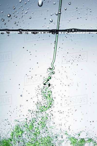 Washing up liquid being squirted into a sink of water - Royalty-free ...