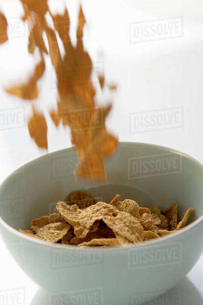 Cereal flakes falling into a cereal bowl - Royalty-free Stock Photo ...