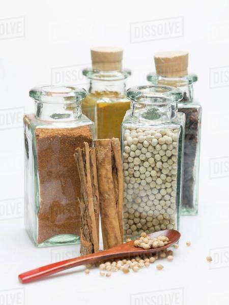 Various spices in spice bottles and cinnamon sticks - Royalty-free ...