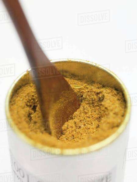 Indian curry powder in container - Stock Photo - Dissolve