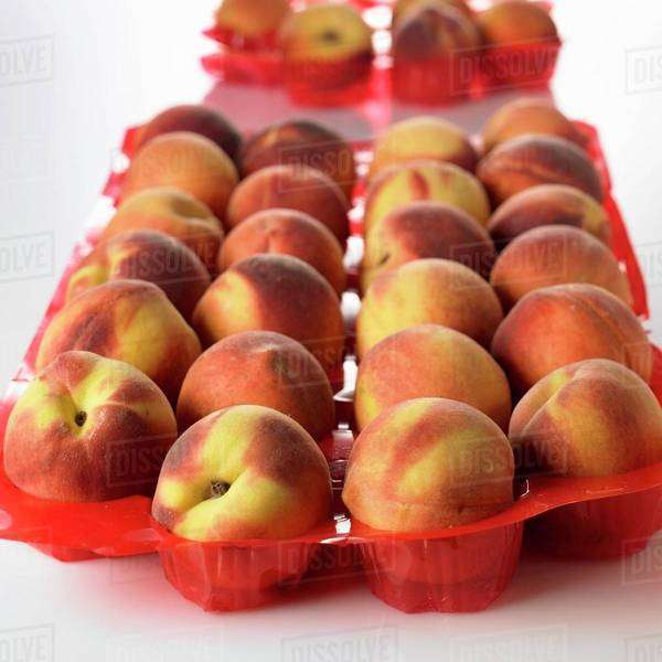 Peaches in plastic tray - Royalty-free Stock Photo | Dissolve