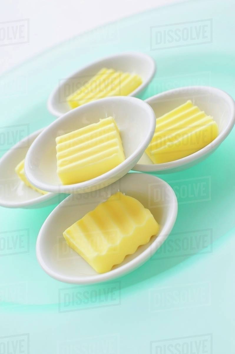 Portions of butter in small dishes - Royalty-free Stock Photo | Dissolve