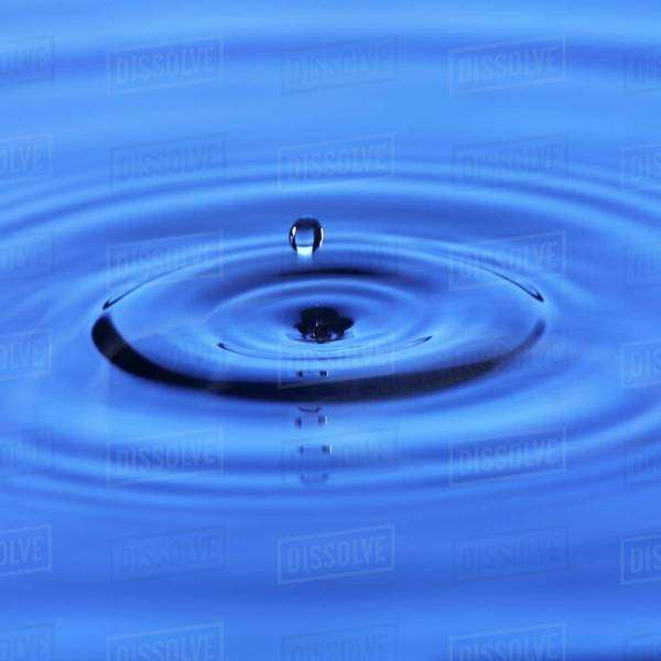 Drop of water falling into water - Royalty-free Stock Photo | Dissolve