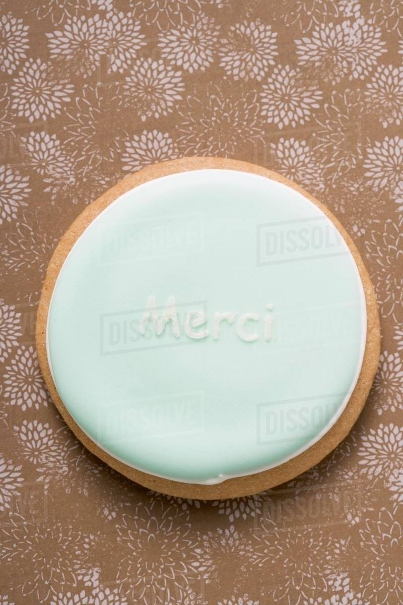 A pastel-coloured biscuit with the word 'Merci' - Royalty-free Stock ...