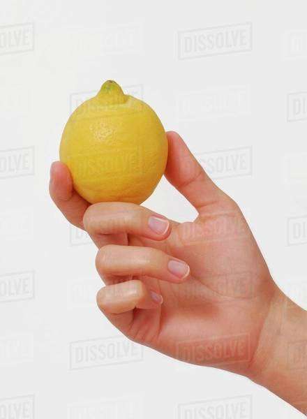 Hand holding a lemon - Royalty-free Stock Photo | Dissolve
