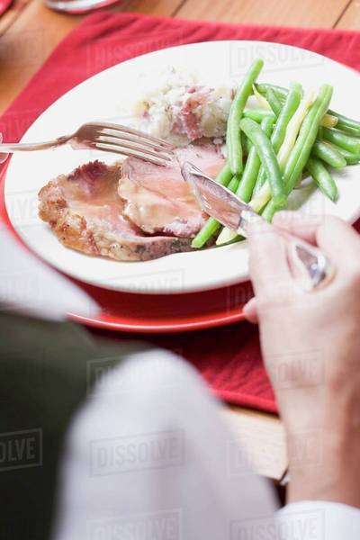Woman eating roast turkey with green beans (Christmas) - Stock Photo ...