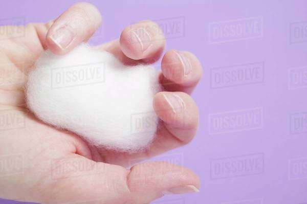 Hand holding cotton wool ball - Royalty-free Stock Photo | Dissolve