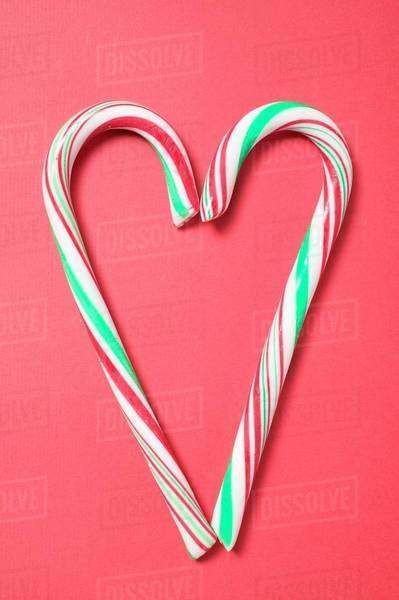 Two candy canes forming a heart - Stock Photo - Dissolve