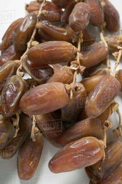 Fresh dates with stalks (close-up) - Stock Photo - Dissolve