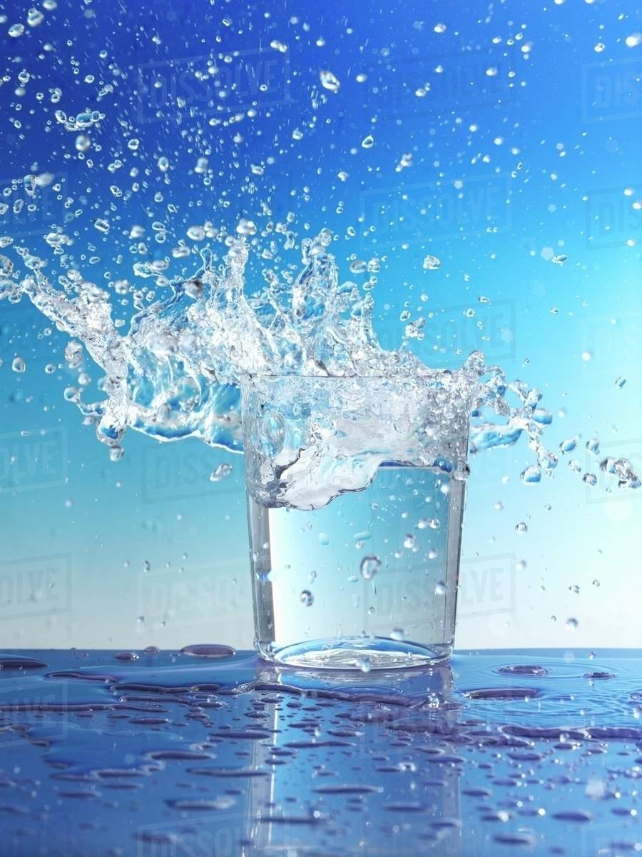 Water splashing out of glass - Royalty-free Stock Photo | Dissolve