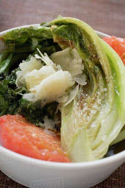 Braised romaine lettuce with tomatoes and Parmesan - Stock Photo - Dissolve
