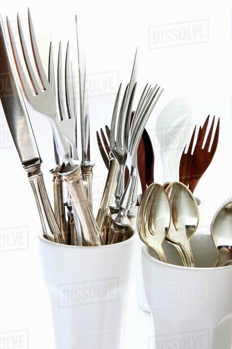 Silver cutlery in coffee beakers - Stock Photo - Dissolve