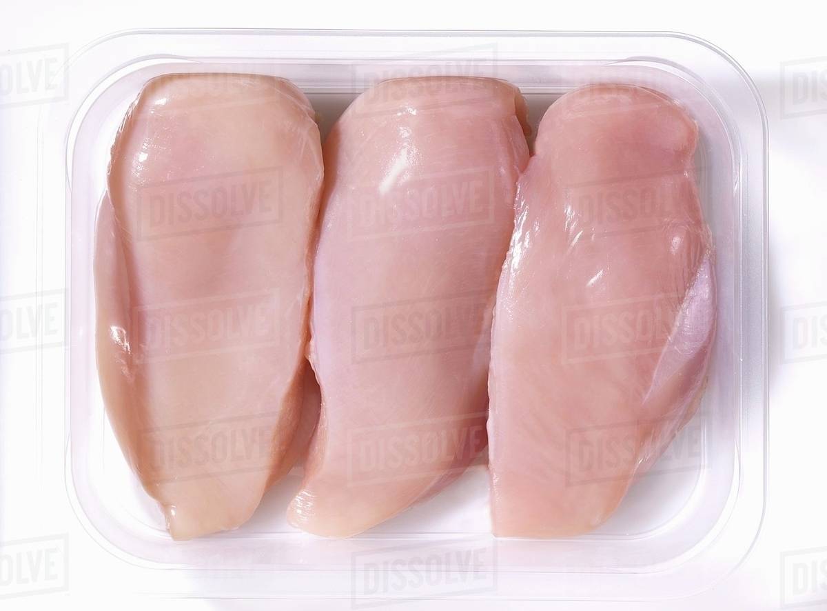 Fresh chicken breast fillets in plastic container - Stock Photo - Dissolve