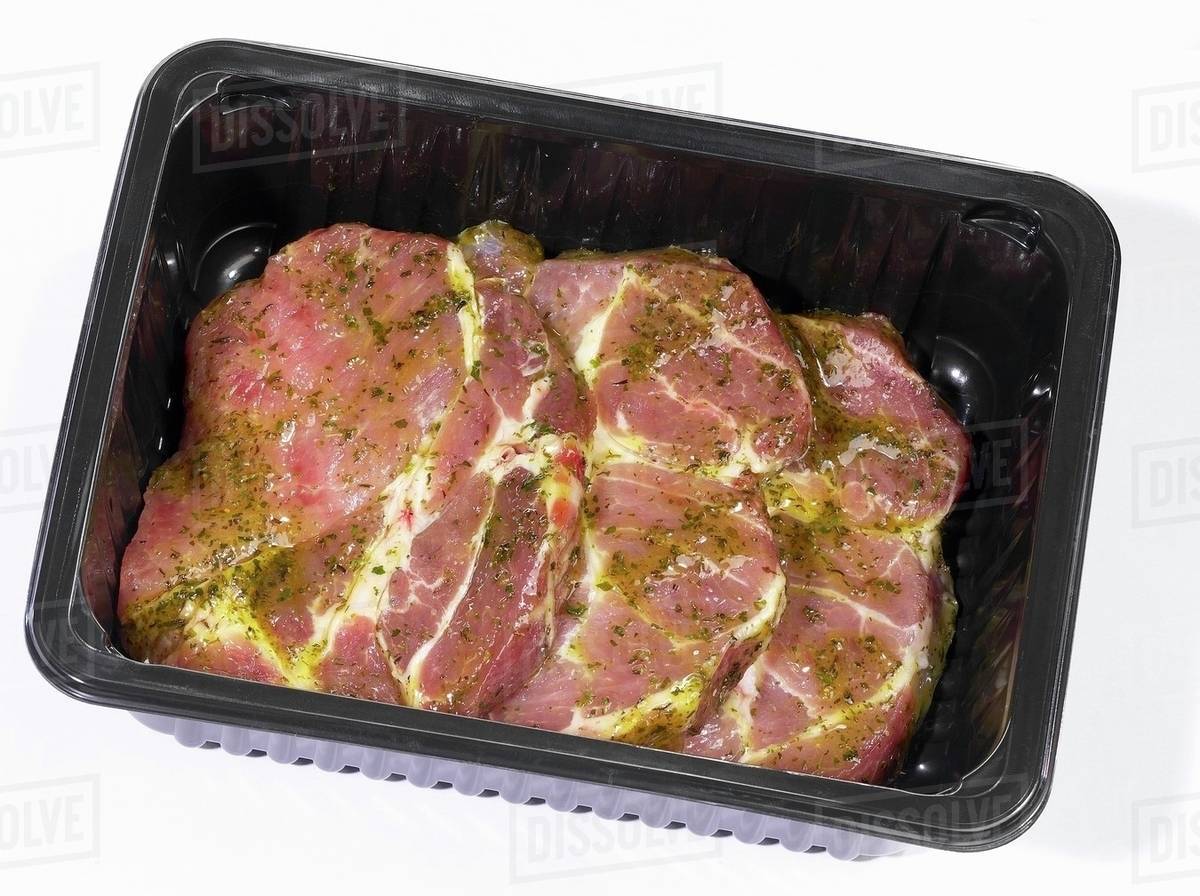 Marinated pork neck steaks in plastic container - Royalty-free Stock ...