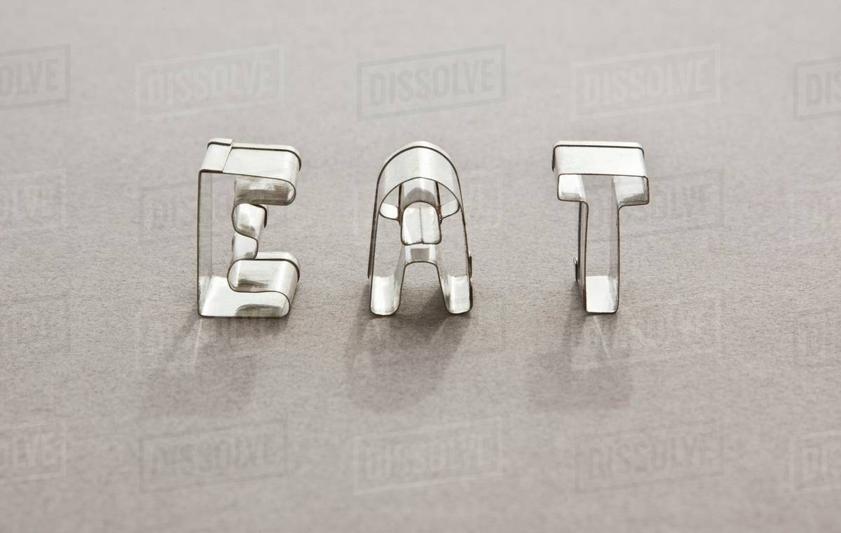 The word EAT made with letter shaped cutters - Stock Photo - Dissolve