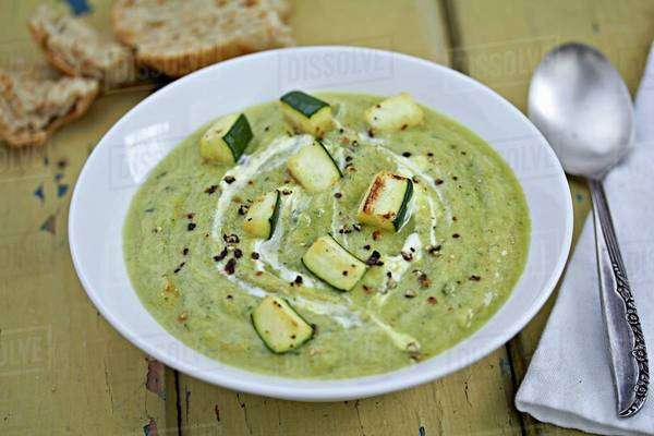 Cream of courgette soup with courgette pieces - Stock Photo - Dissolve