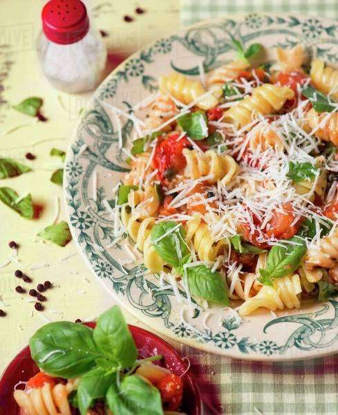 Fusili pasta with tomatoes, basil and grated cheese - Stock Photo ...