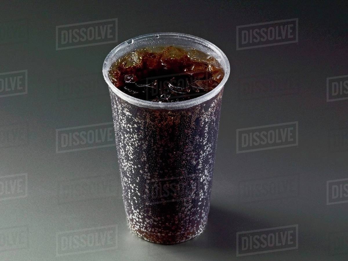 Cola with ice cubes in a plastic cup - Royalty-free Stock Photo | Dissolve