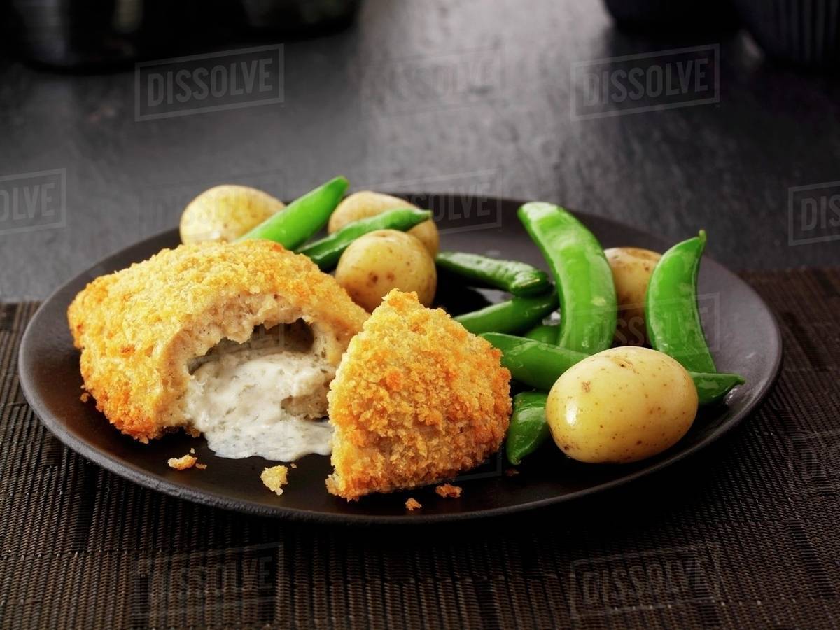 Chicken Kiev with mange tout and potatoes - Royalty-free Stock Photo ...