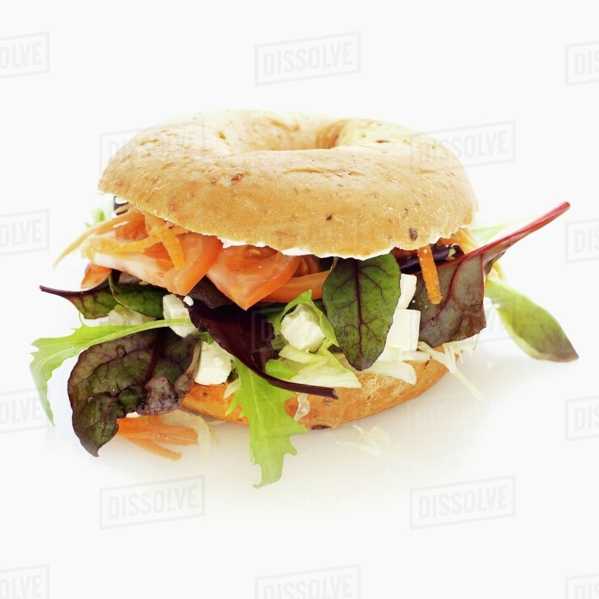 A bagel with feta cheese, lettuce, tomato and carrot - Royalty-free ...