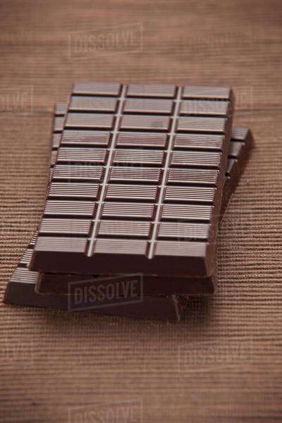 Three bars of dark chocolate - Royalty-free Stock Photo | Dissolve