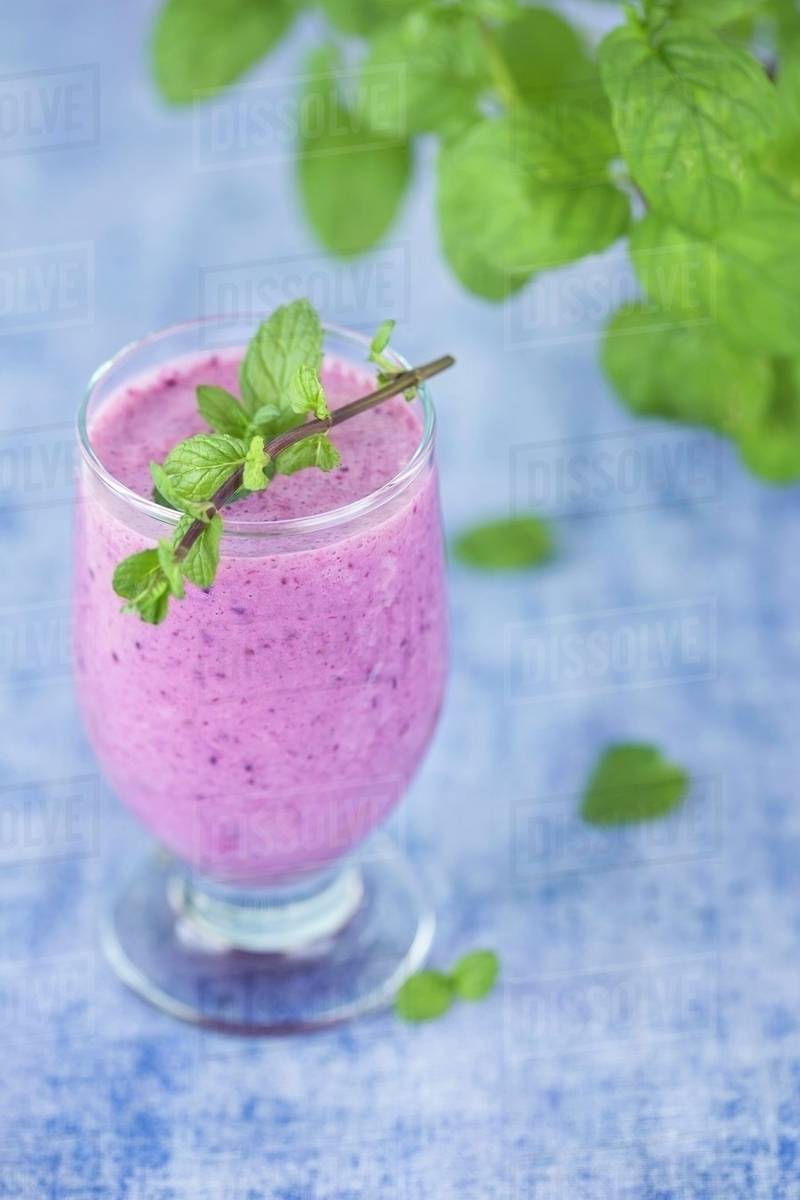 Pink berry smoothie with fresh mint - Royalty-free Stock Photo | Dissolve
