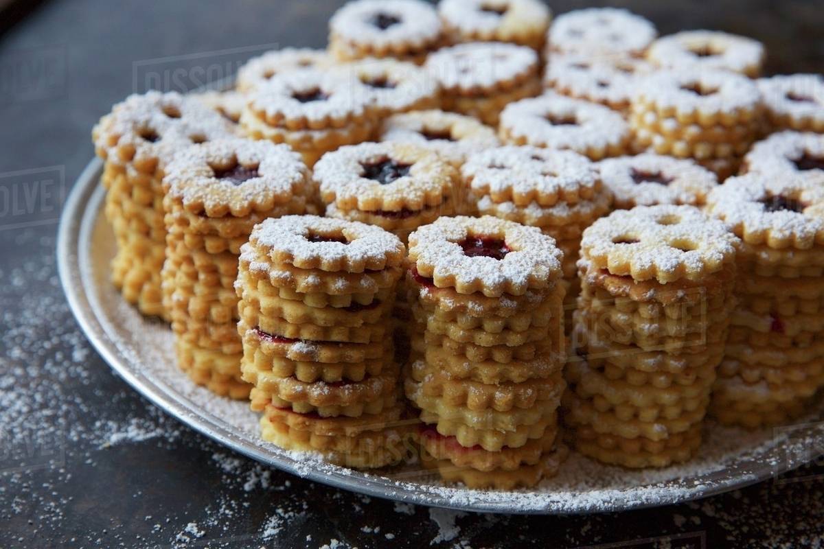Stacks of jammy shortbread biscuits with icing sugar - Royalty-free ...