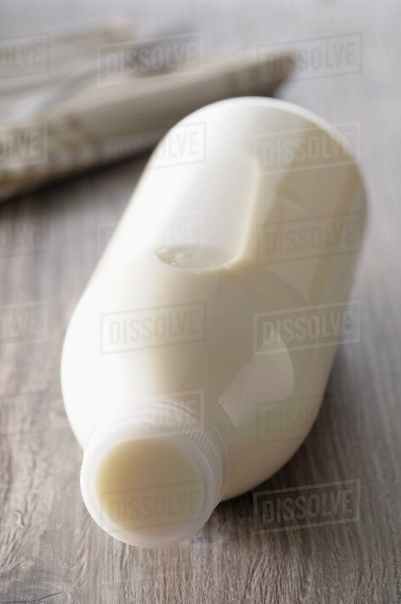 A bottle of milk lying on its side - Royalty-free Stock Photo | Dissolve