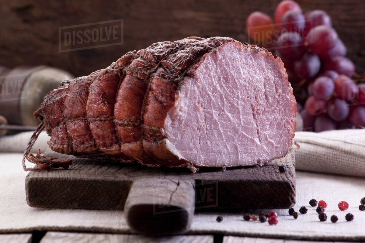 A whole smoked ham in a net - Royalty-free Stock Photo | Dissolve