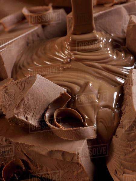 Melted Chocolate Pouring Over Chocolate Chunks - Stock Photo - Dissolve