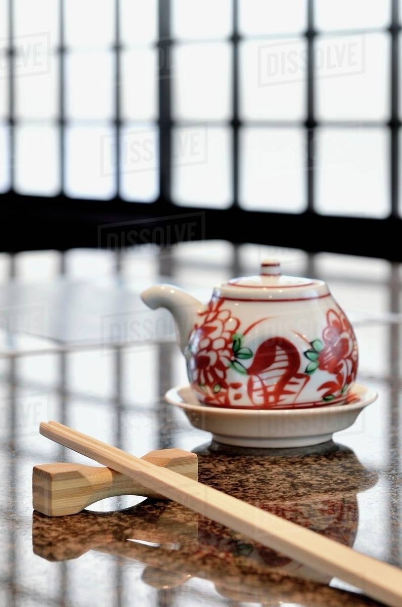 A Japanese table set with chopsticks and a sake pot - Stock Photo ...