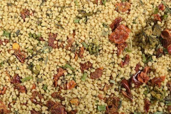 A ready-made mix of couscous with dried vegetables and spices - Stock ...