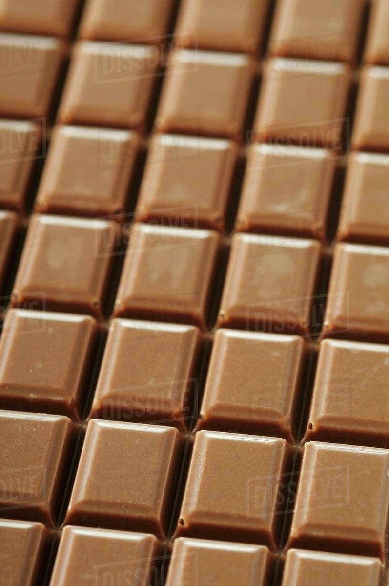 A bar of milk chocolate (filling the image) - Stock Photo - Dissolve