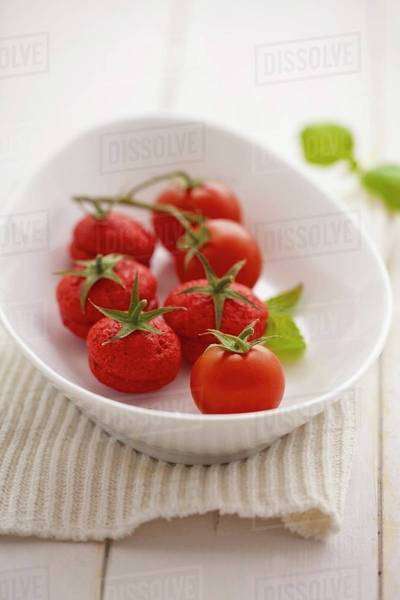 Strawberry macaroons and cherry tomatoes - Stock Photo - Dissolve