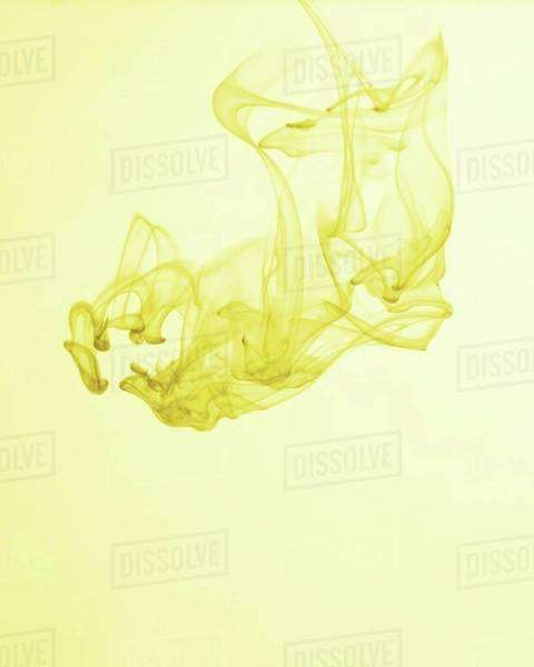 Yellow ink dripping into water - Royalty-free Stock Photo | Dissolve