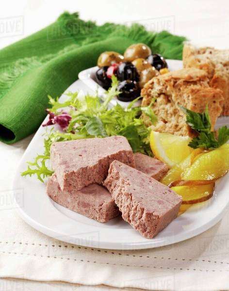 Ardennes pate (meat paste, Belgium) with lettuce, bread and olives ...