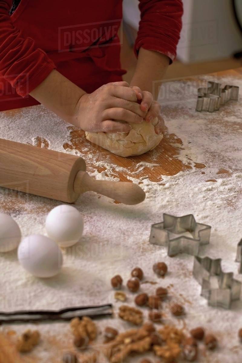 A child kneading biscuit dough on a floured work surface - Stock Photo ...