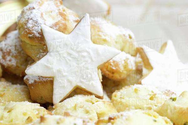 Stollen bites and star-shaped biscuits topped with coconut - Stock ...