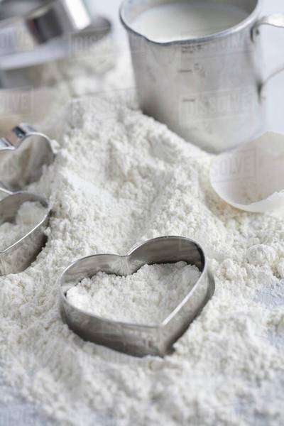 Baking ingredients and heart-shaped cutters - Royalty-free Stock Photo ...