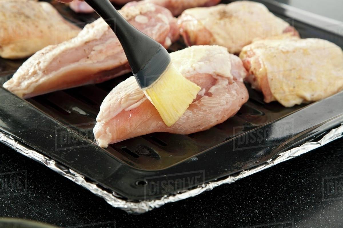 Brushing Chicken with Melted Butter; Chicken on a Broiling Pan - Stock ...