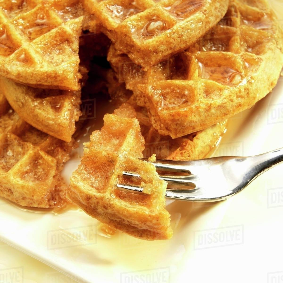 Stack of Five Grain Waffle with Organic Maple Syrup; Piece on a Fork ...