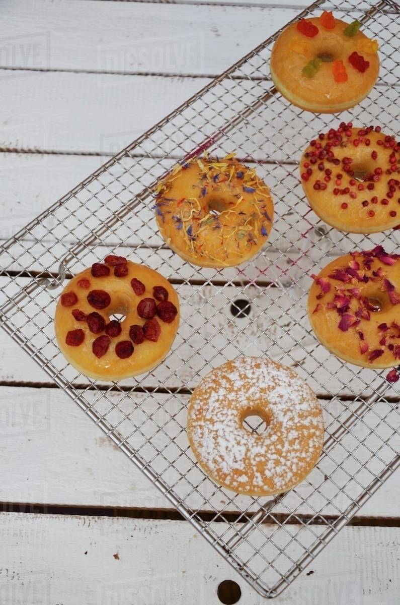 Doughnuts with various toppings on a wire rack - Royalty-free Stock ...