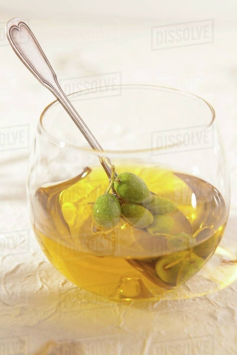 Glass with olives and olive oil - Royalty-free Stock Photo | Dissolve