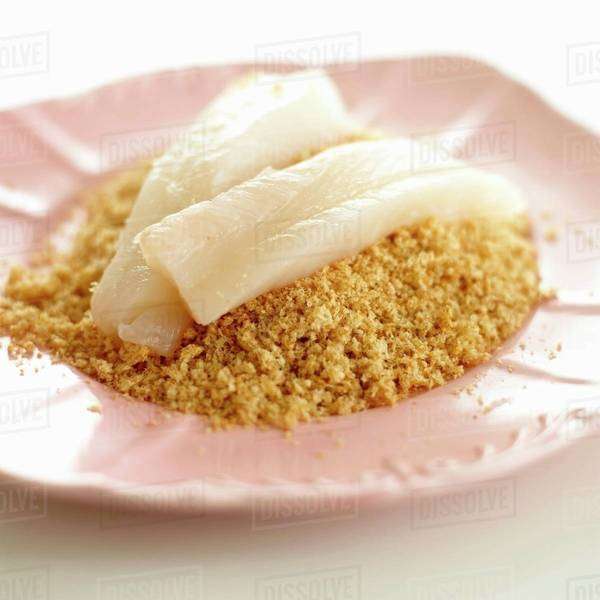 Raw fish fillets on a pile of breadcrumbs - Royalty-free Stock Photo ...