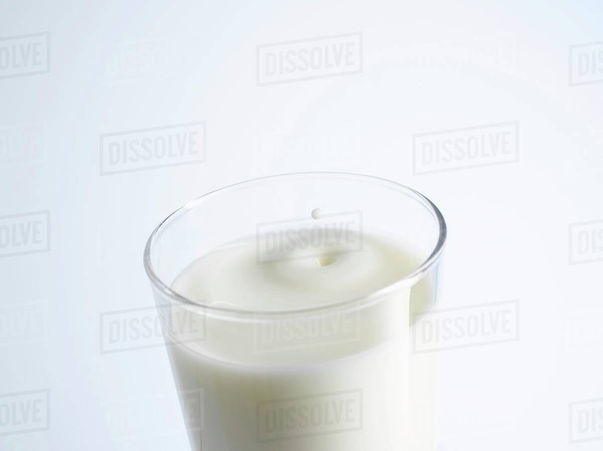 A glass of milk with a drop of milk - Royalty-free Stock Photo | Dissolve