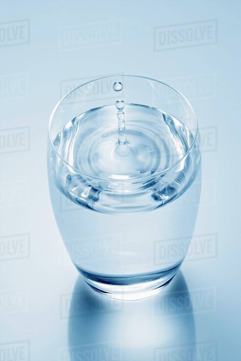 Drop of water falling into a glass - Royalty-free Stock Photo | Dissolve