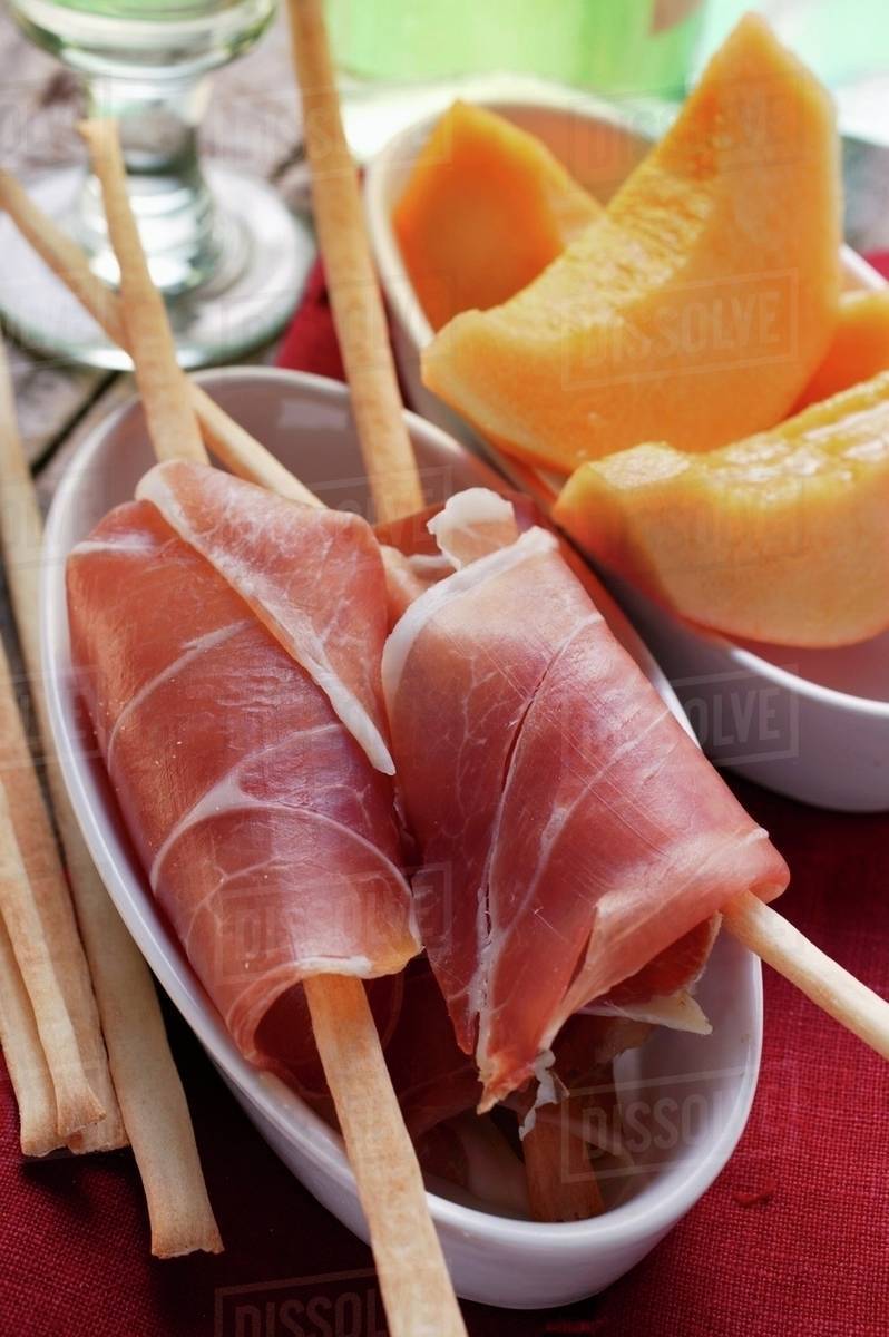 Parma ham with grissini; melon - Royalty-free Stock Photo | Dissolve