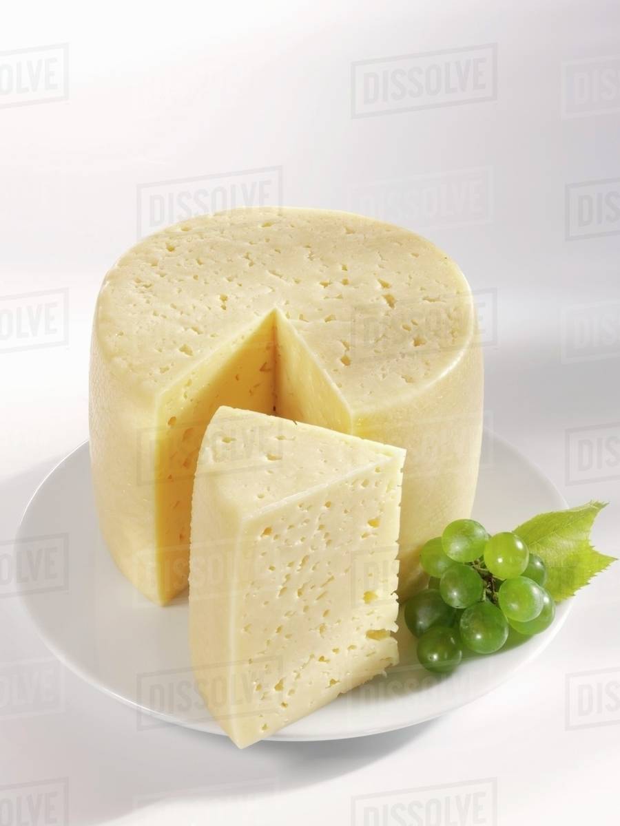 Tilsiter cheese, a wedge cut, with grapes - Royalty-free Stock Photo ...