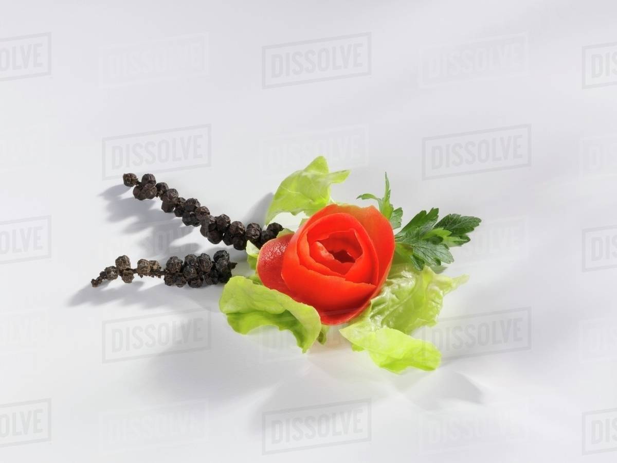 Tomato rose with lettuce leaf and bunches of pepper - Stock Photo ...