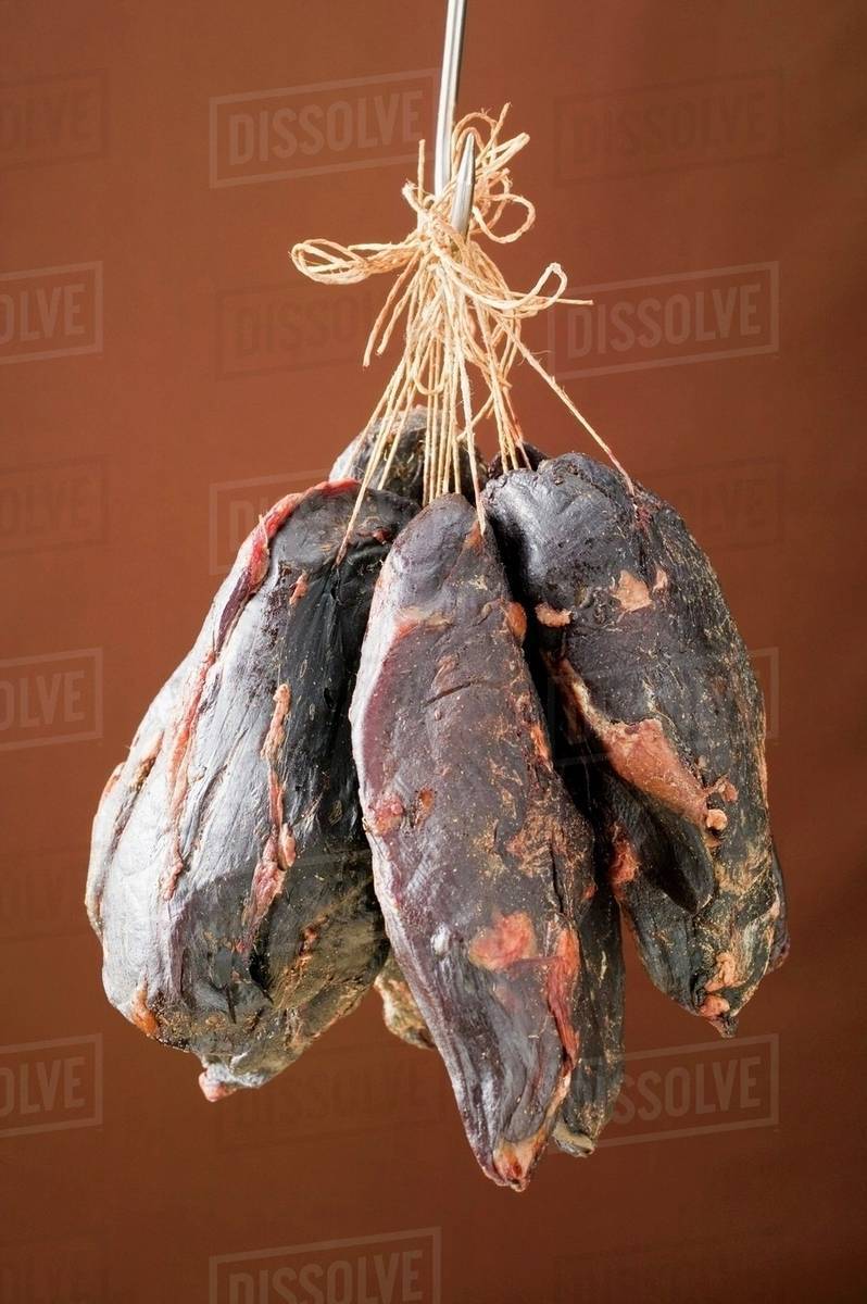 Smoked venison ham on a hook - Royalty-free Stock Photo | Dissolve